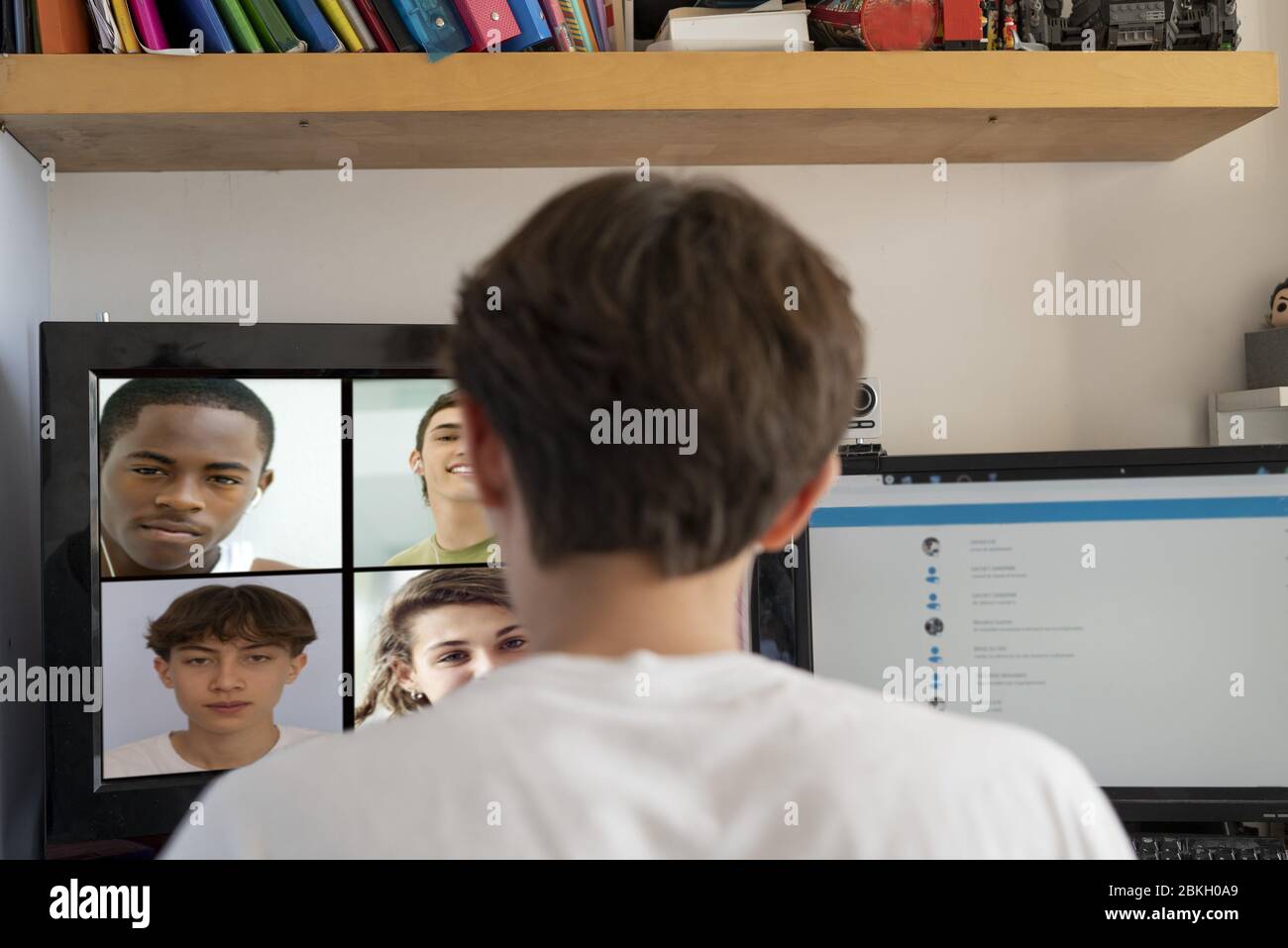 Teenage boy video chatting on the computer with friends at home Stock ...