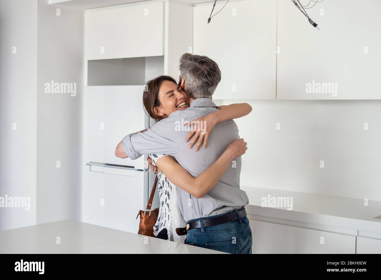 Embracing smiling happiness excitement bonding standing hi-res stock ...