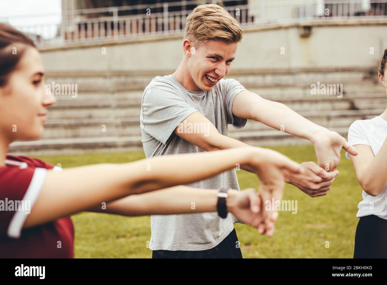 Group of boys and girls exercising in physical training class at high ...