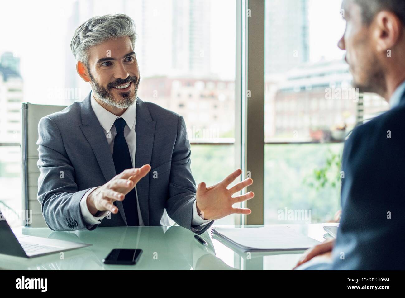 Sitting smiling gesturing communication hi-res stock photography and ...