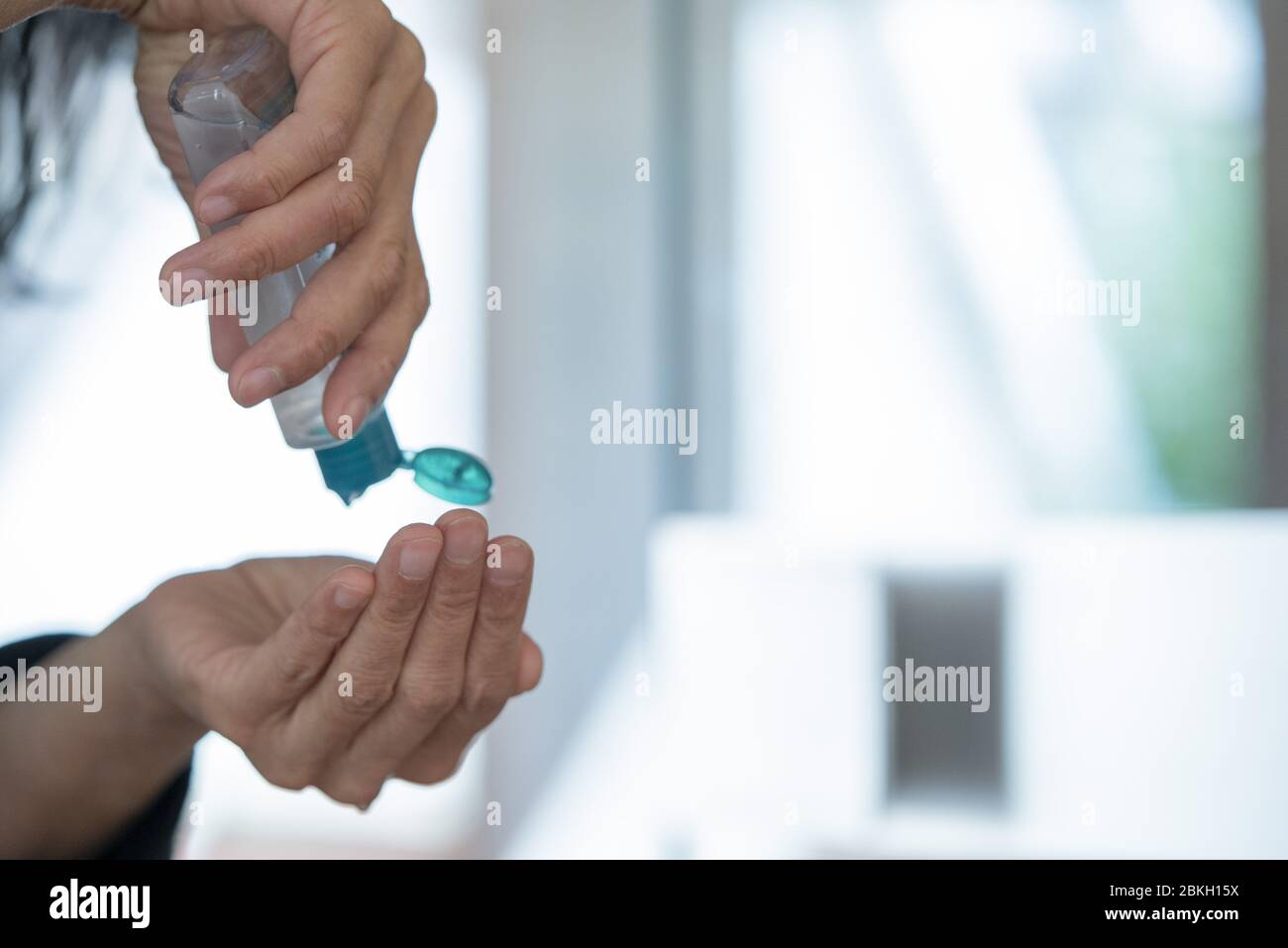 Man's hands applying alcohol sanitizer gel Stock Photo - Alamy