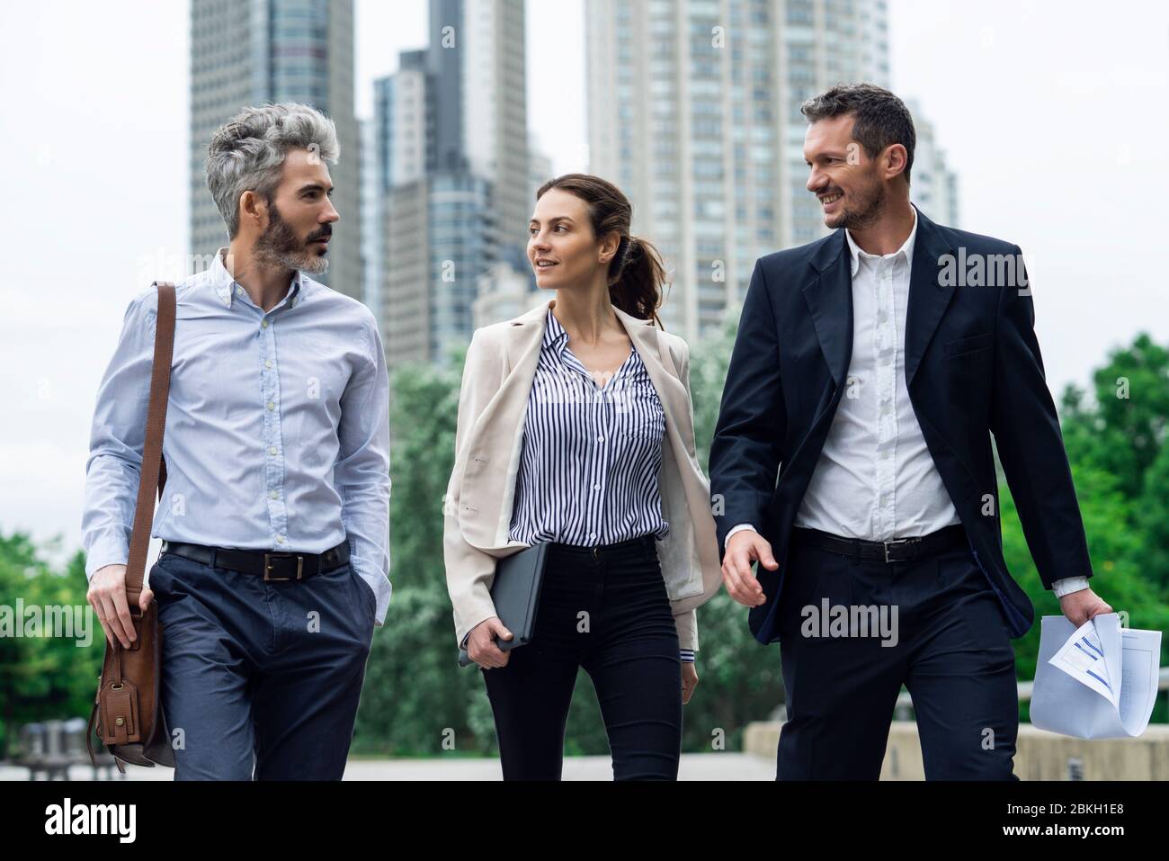 Architects talking with each other in public park Stock Photo - Alamy