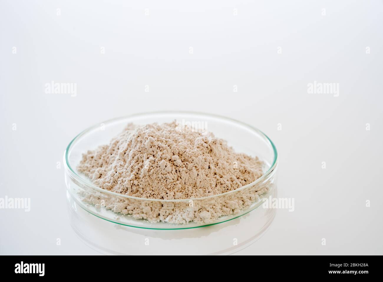Calcium carbonate salt in petri dish on white background Stock Photo ...