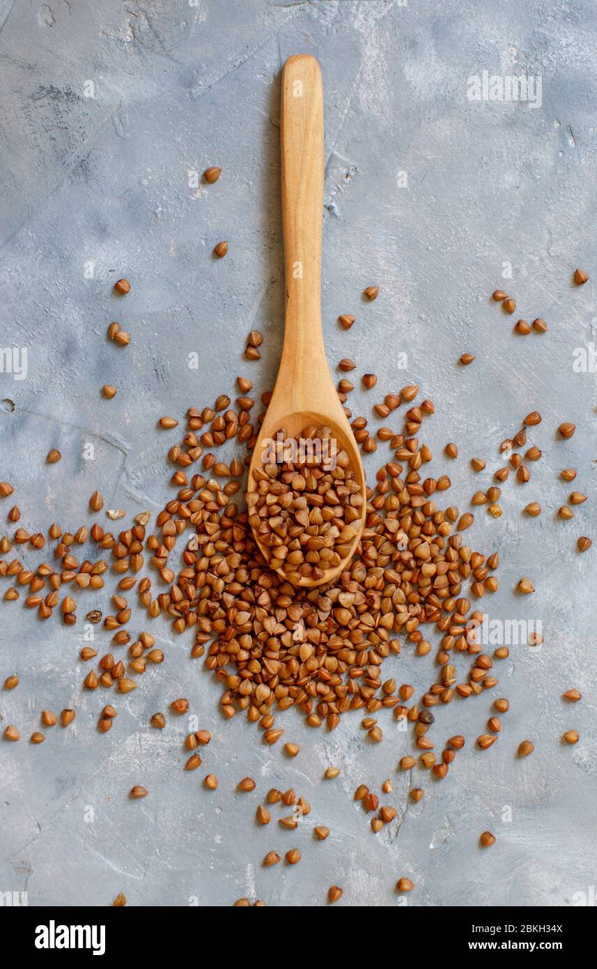 Raw dry buckwheat grain with a spoon top view Stock Photo - Alamy