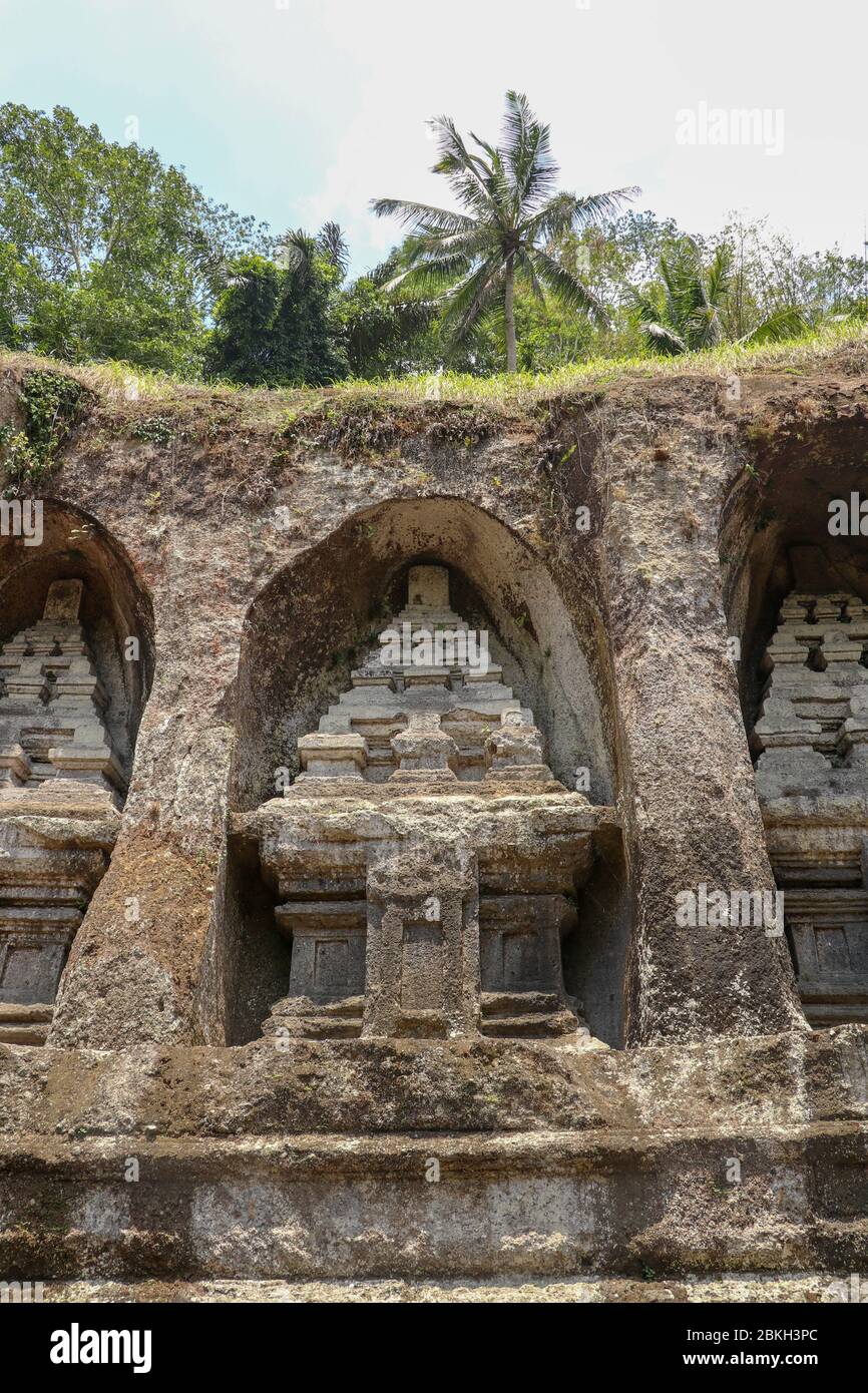 Candi (shrines) carved into a rock in a valley by the Pakerisan River ...