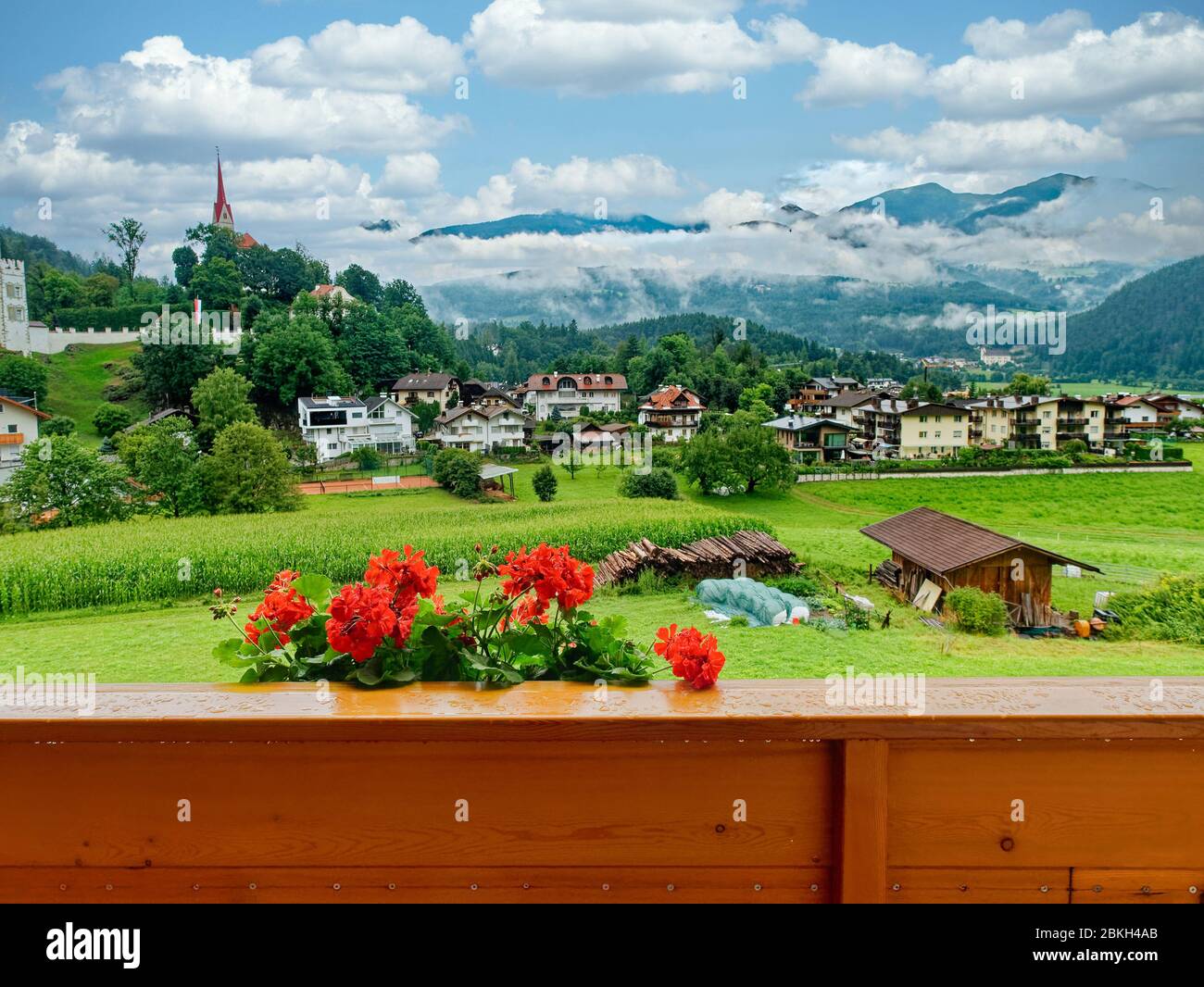 panoramic countryside mountain view from balcony with red flowers Stock ...