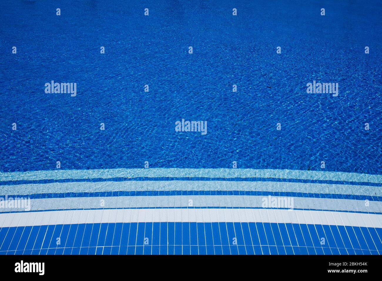 Steps to the pool, blue clear water in the outdoor swimming pool, safe ...