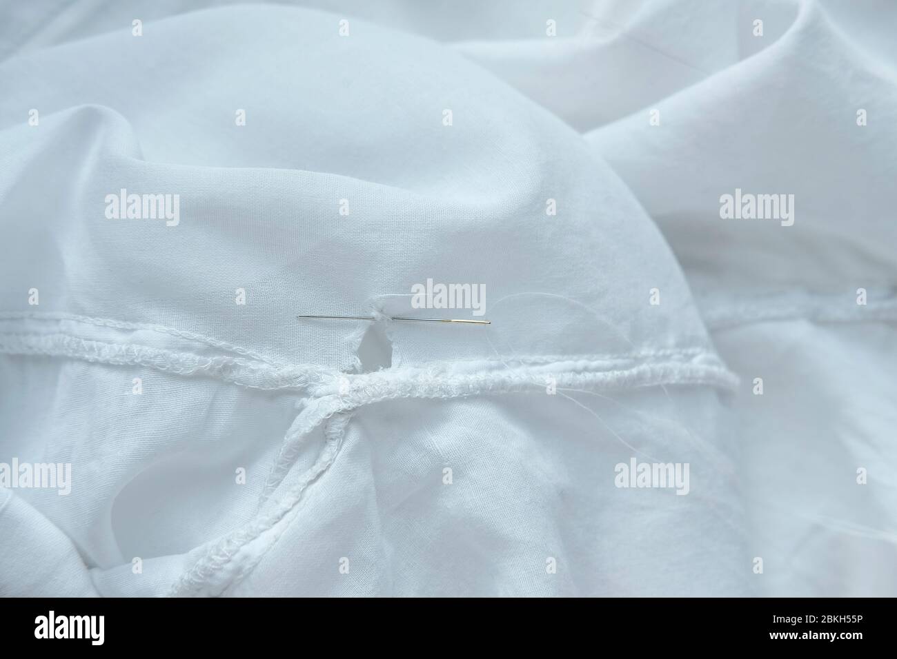 Mending clothes. Repairing fabric, shopping less concept. White dress ...