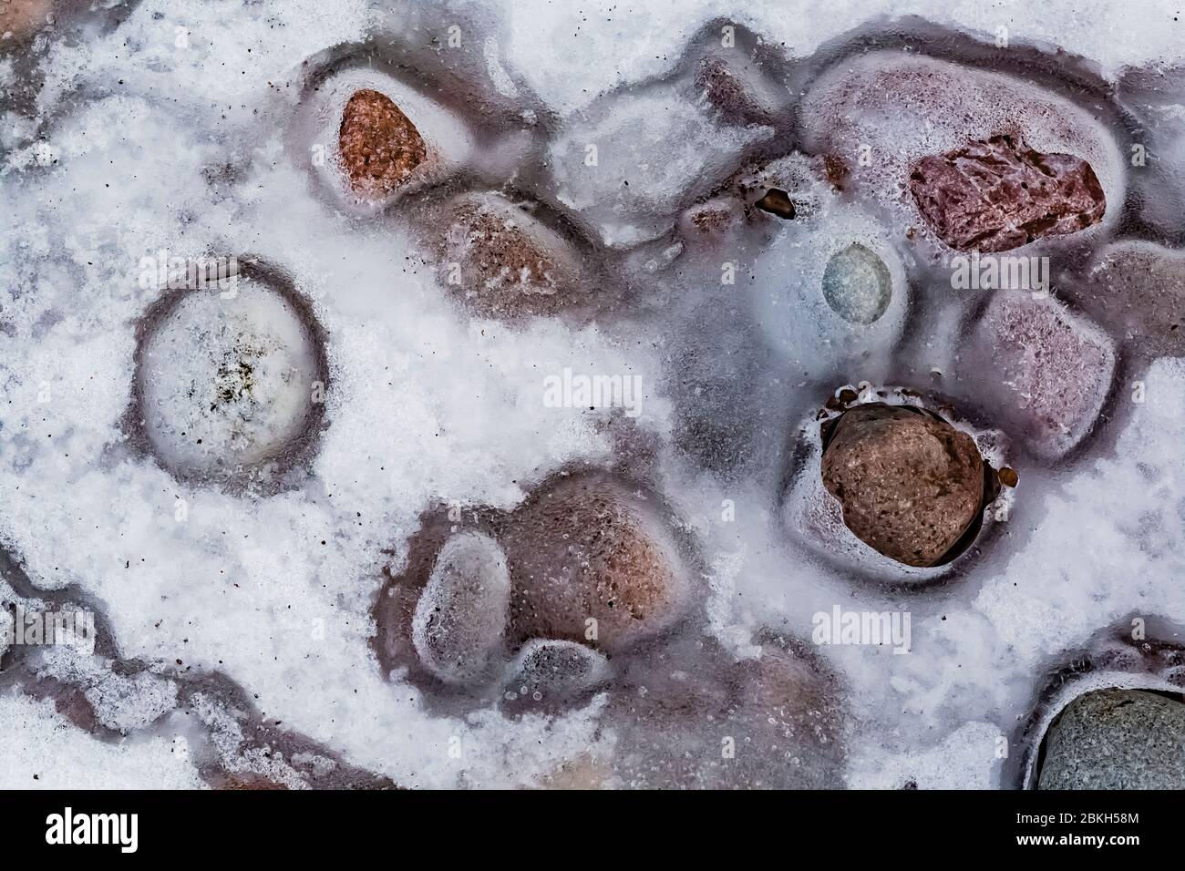 Stones covered with ice formed when water splashed up from Lake Superor ...