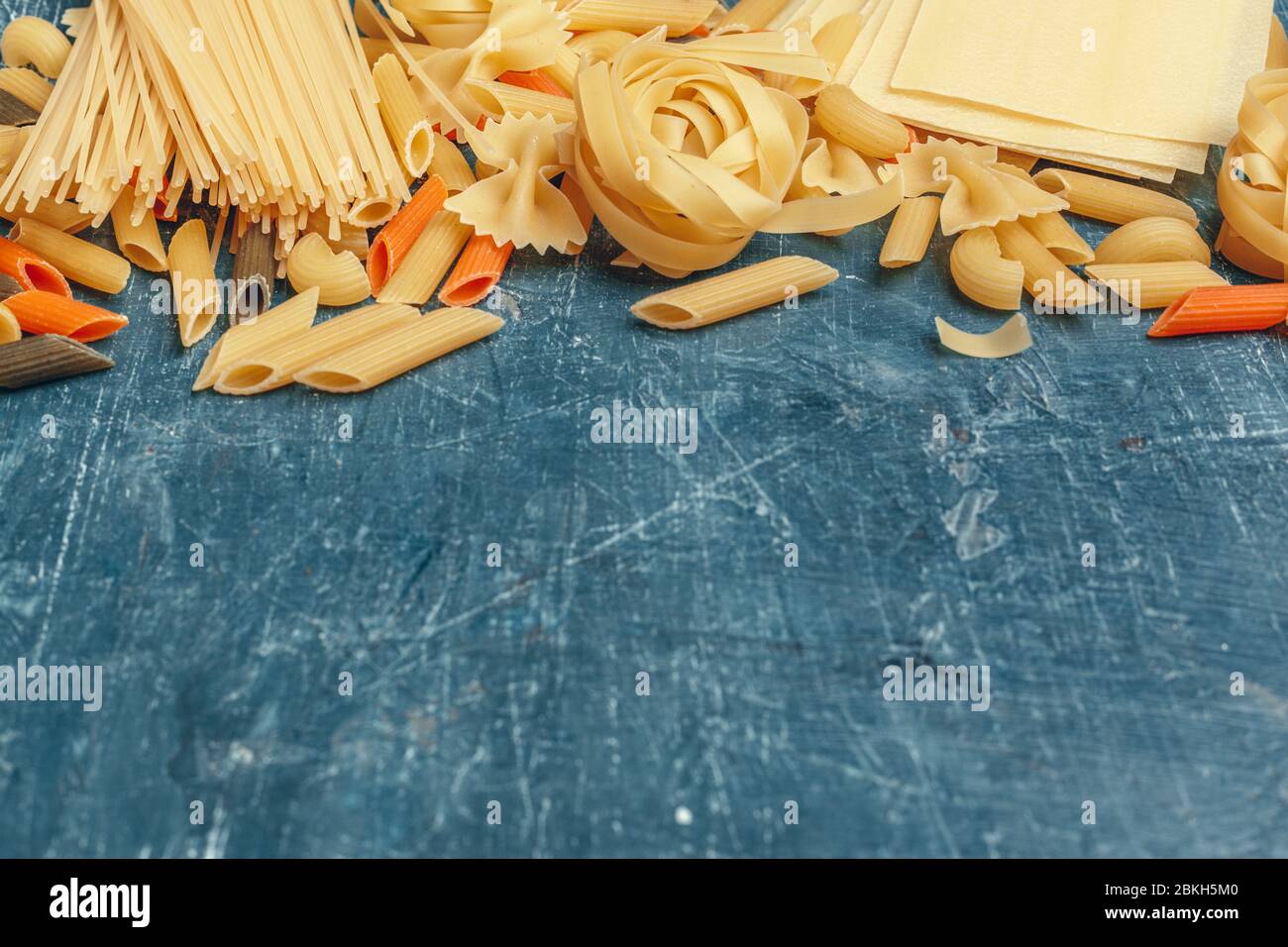Various types of Italian pasta rustic background Stock Photo - Alamy