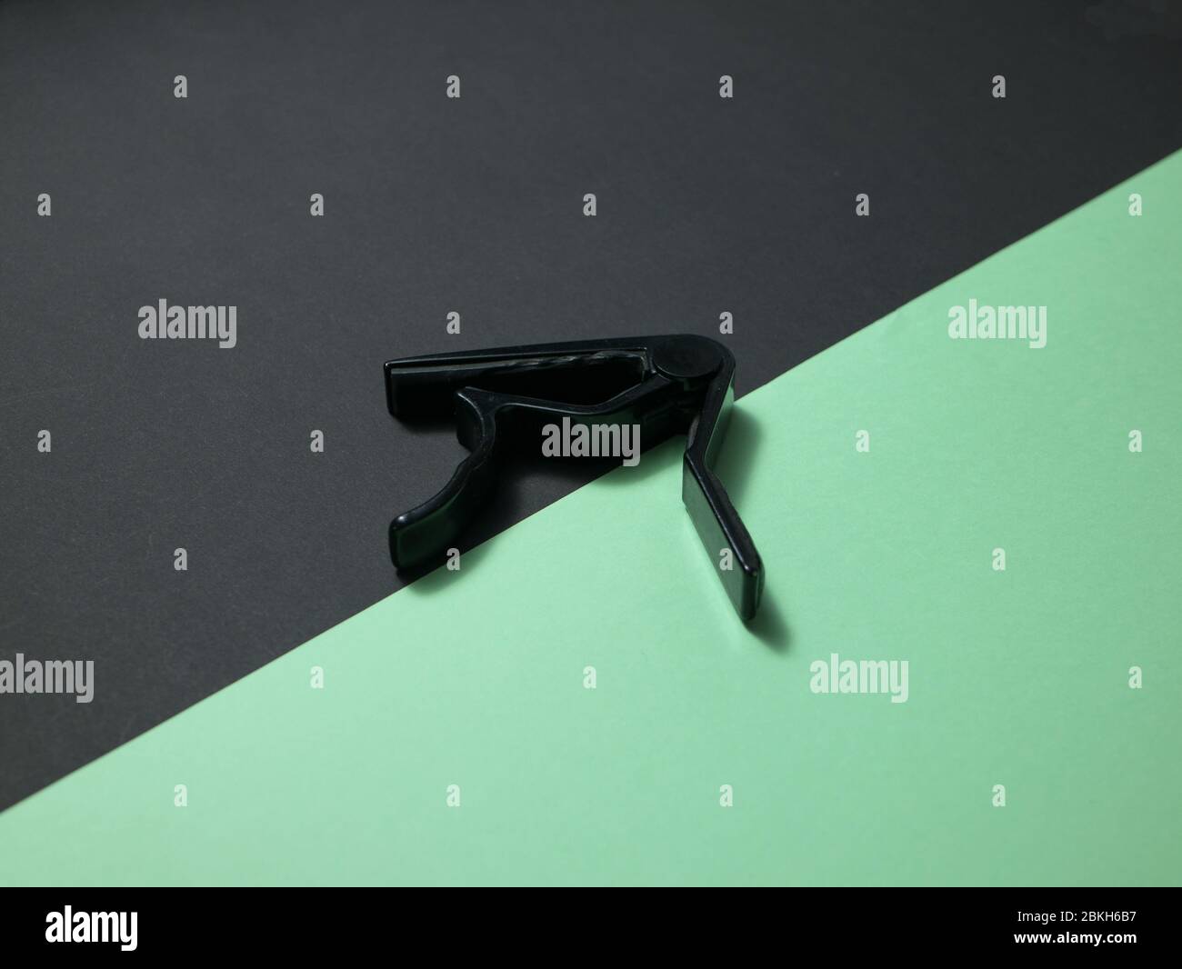 Music instrument accessories - Guitar capo isolated colored background ...