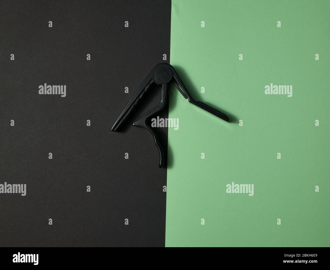 Music instrument accessories - Guitar capo isolated colored background ...