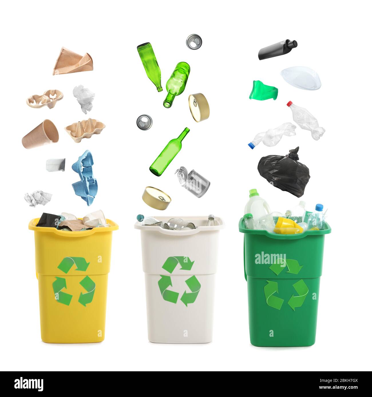 Garbage falling into containers on white background. Recycling concept ...
