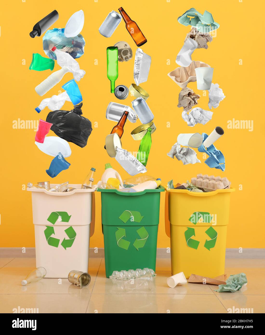 Garbage falling into containers near color wall. Recycling concept ...