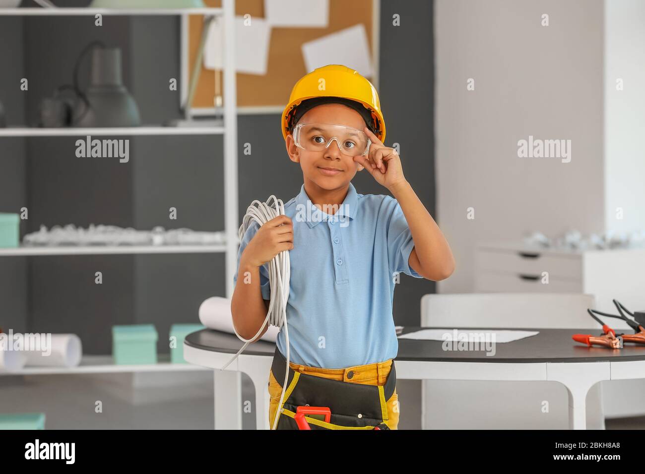 Little African-American electrician in room Stock Photo - Alamy