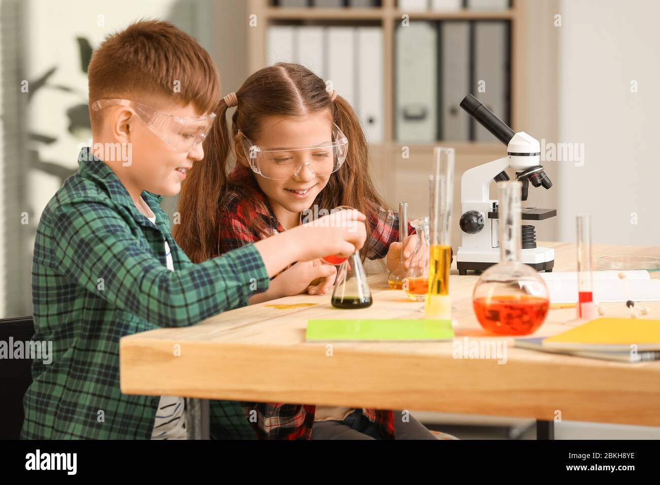 Cute little children at chemistry lesson in classroom Stock Photo - Alamy