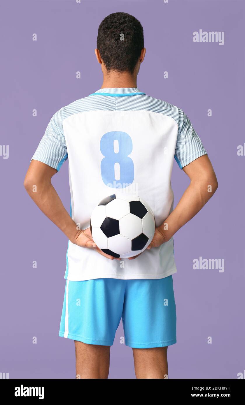 Young African-American football player on color background, back view ...