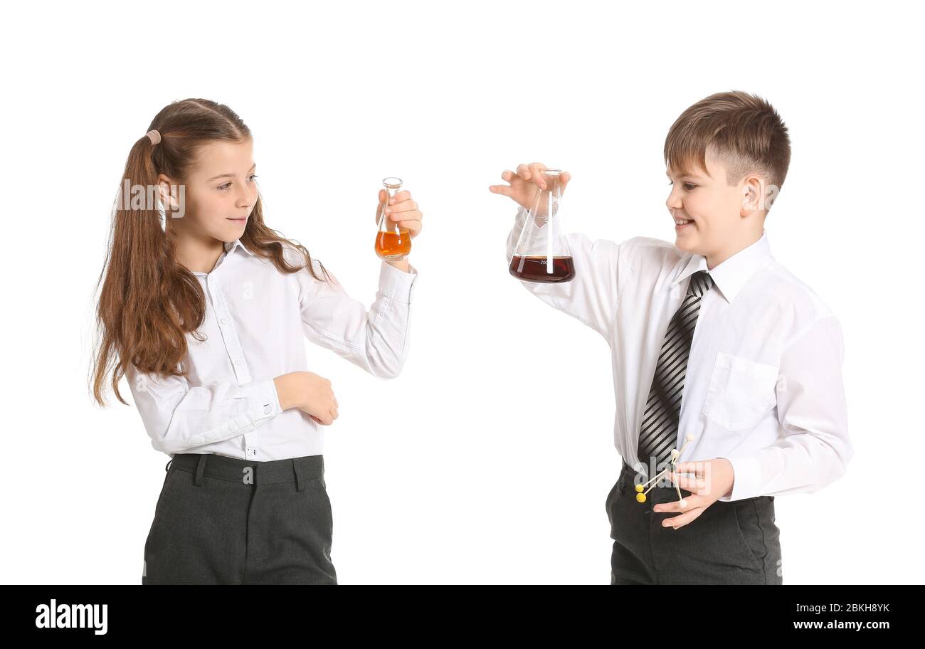 Cute little children with laboratory glassware on white background ...
