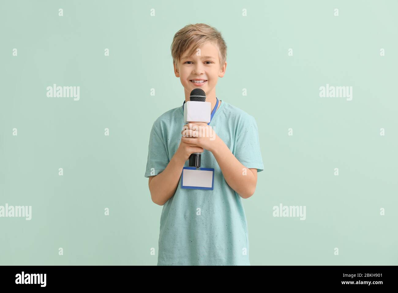 Little journalist with microphone on color background Stock Photo - Alamy