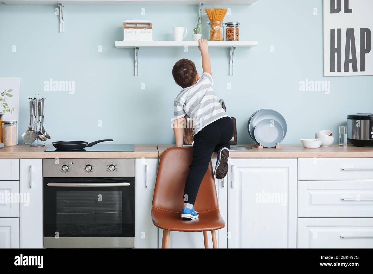 Little boy trying to reach out for pasta at home Stock Photo - Alamy