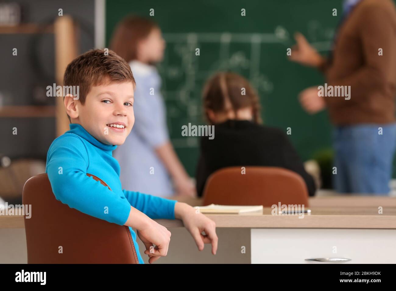 Cute boy at physics lesson in classroom Stock Photo - Alamy