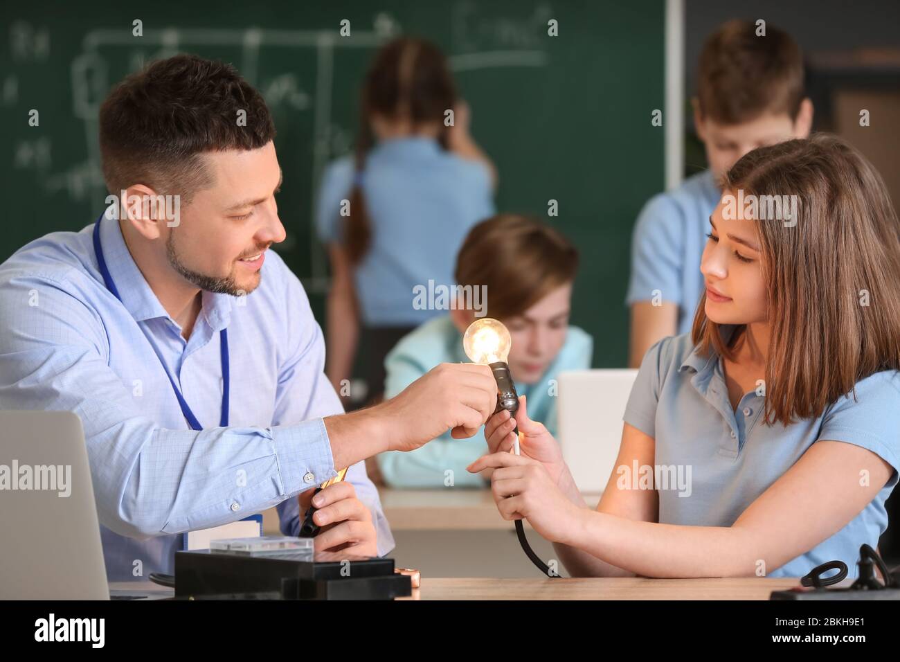 Teacher conducting physics lesson in classroom Stock Photo - Alamy