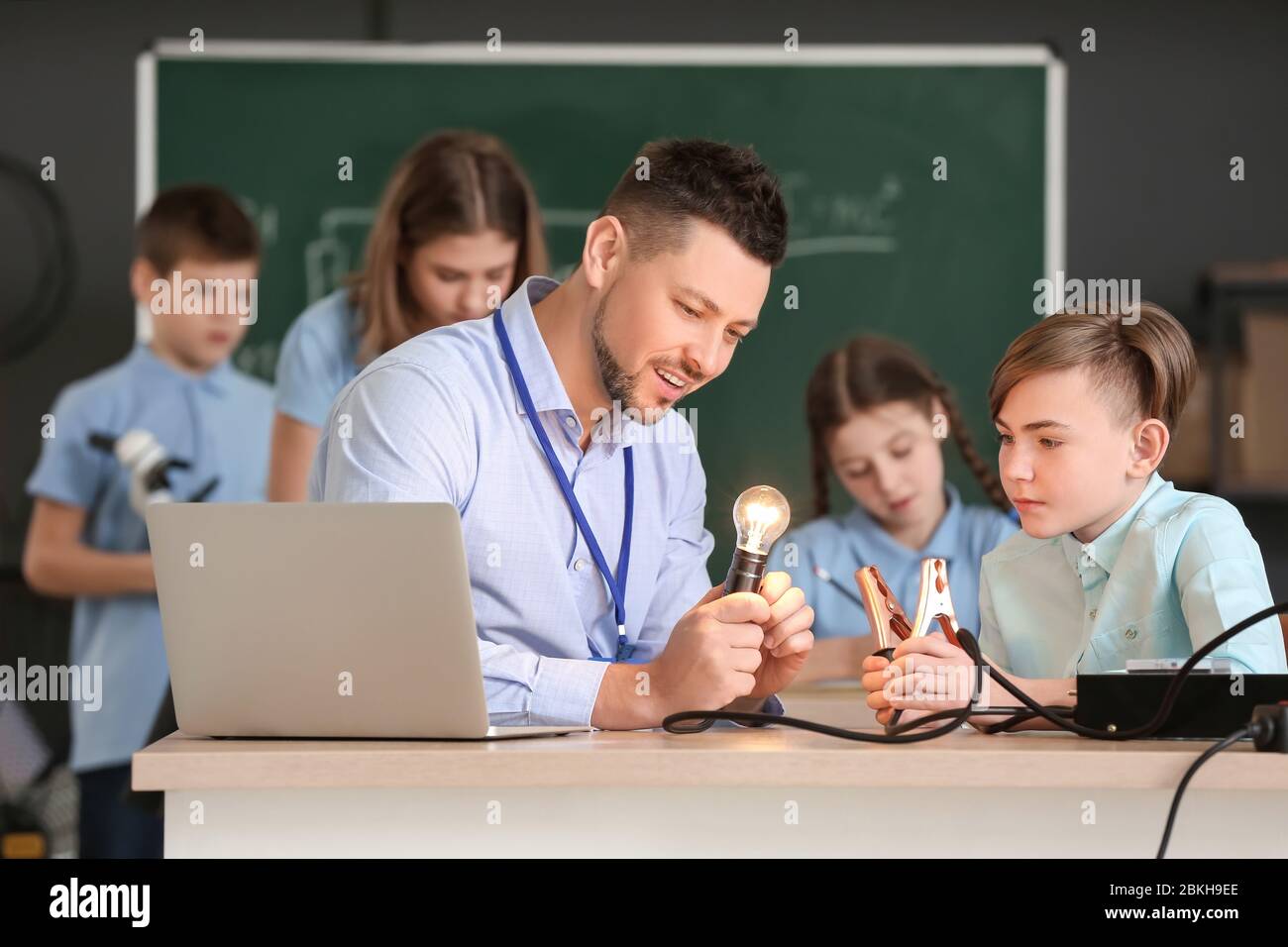 Teacher conducting physics lesson in classroom Stock Photo - Alamy