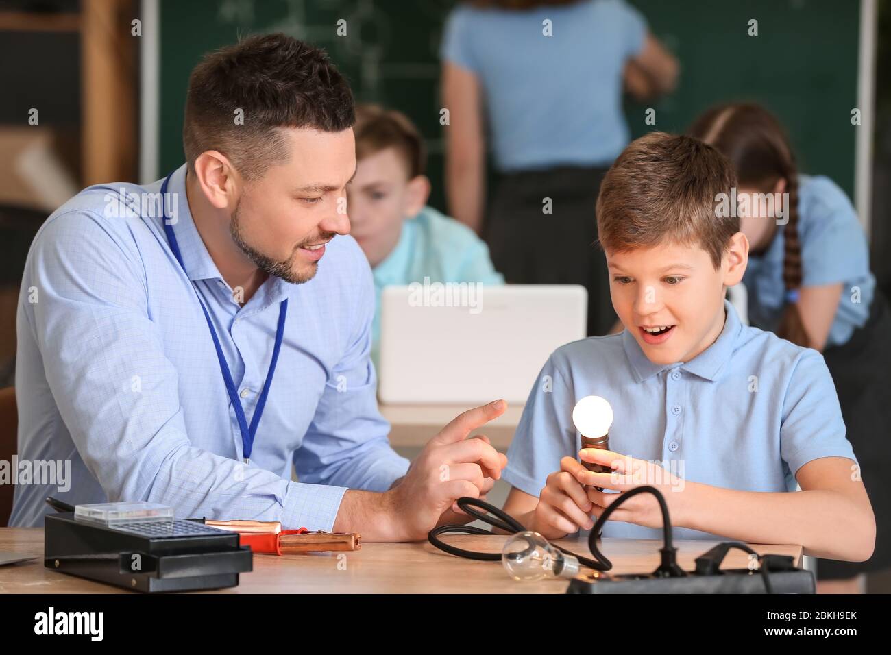 Teacher conducting physics lesson in classroom Stock Photo - Alamy