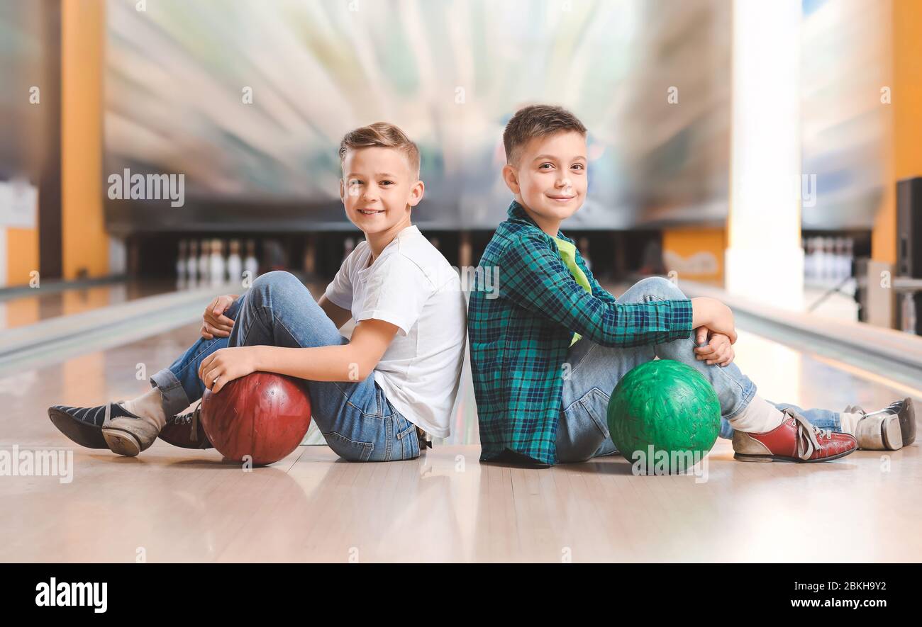 Little boys playing bowling in club Stock Photo - Alamy