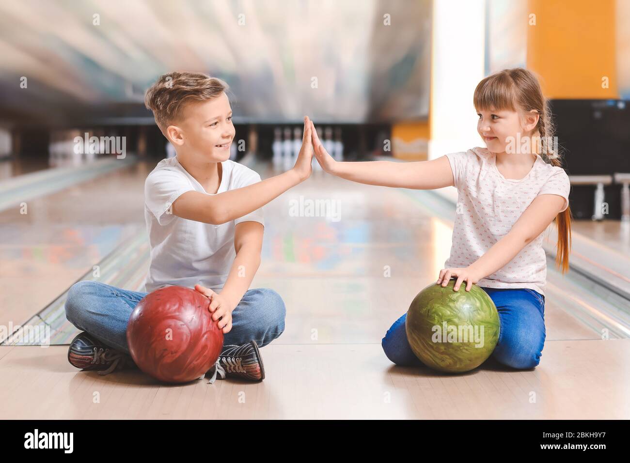 Little children playing bowling in club Stock Photo - Alamy