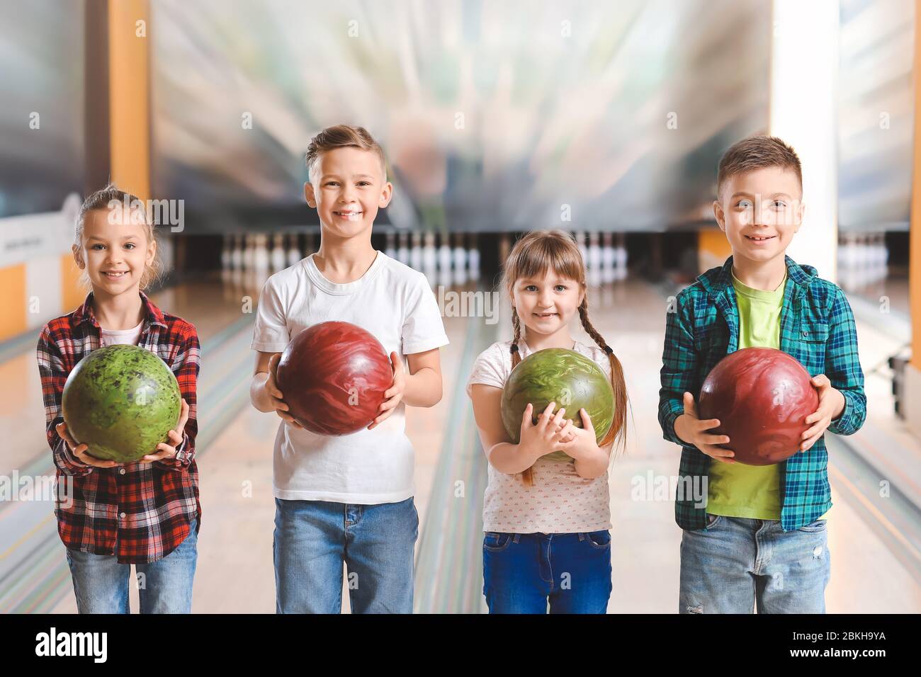 Little children playing bowling in club Stock Photo - Alamy