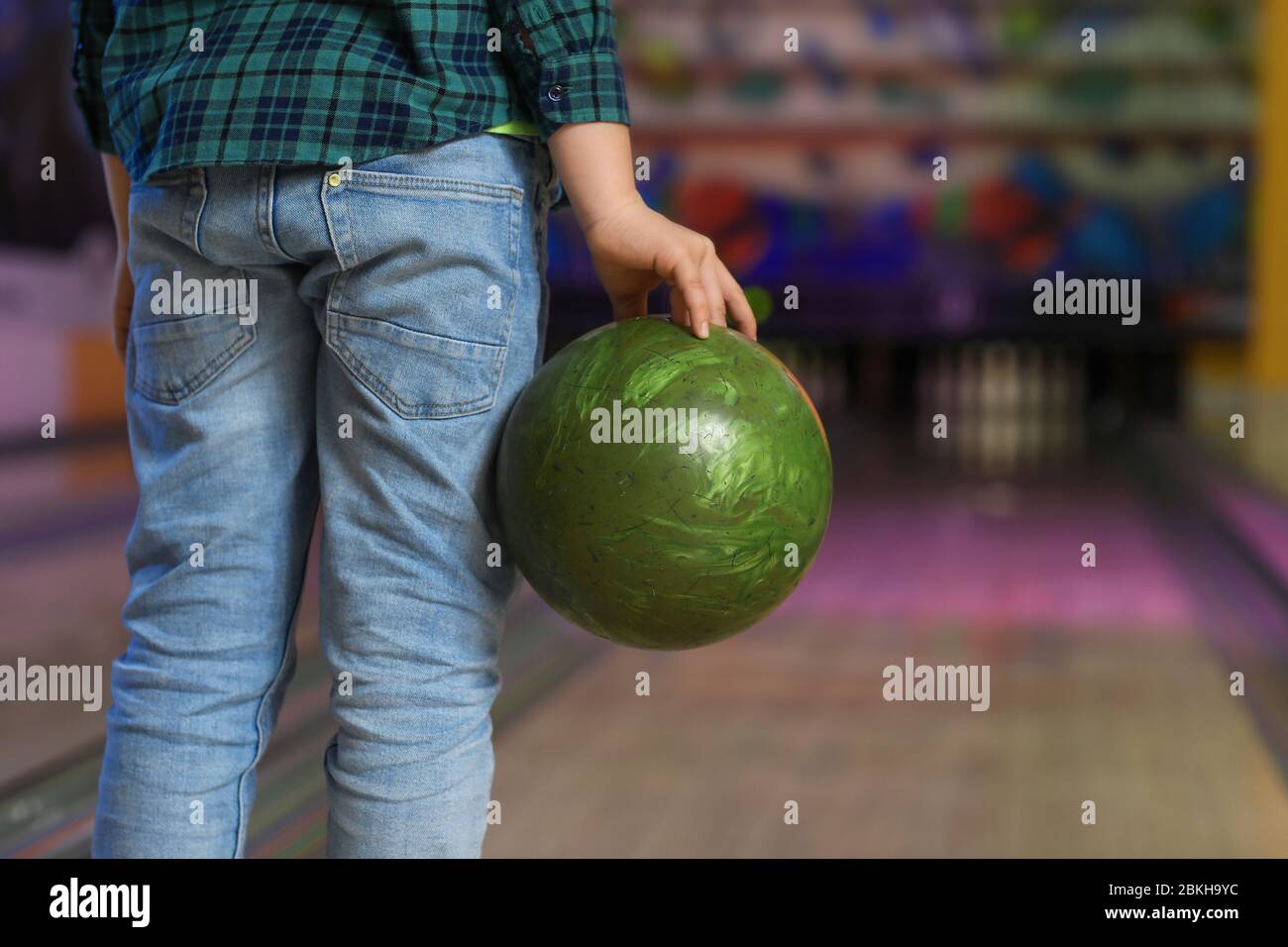 Little boy playing bowling in club Stock Photo - Alamy