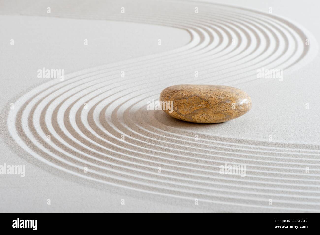 japanese garden with stone in textured sand Stock Photo - Alamy
