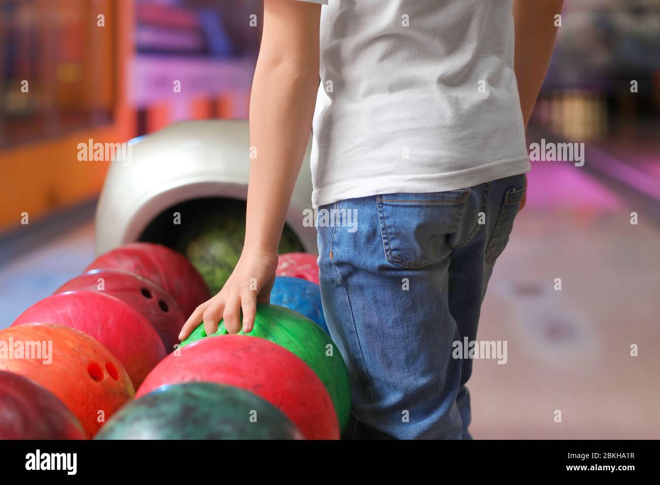 Little boy playing bowling in club Stock Photo - Alamy