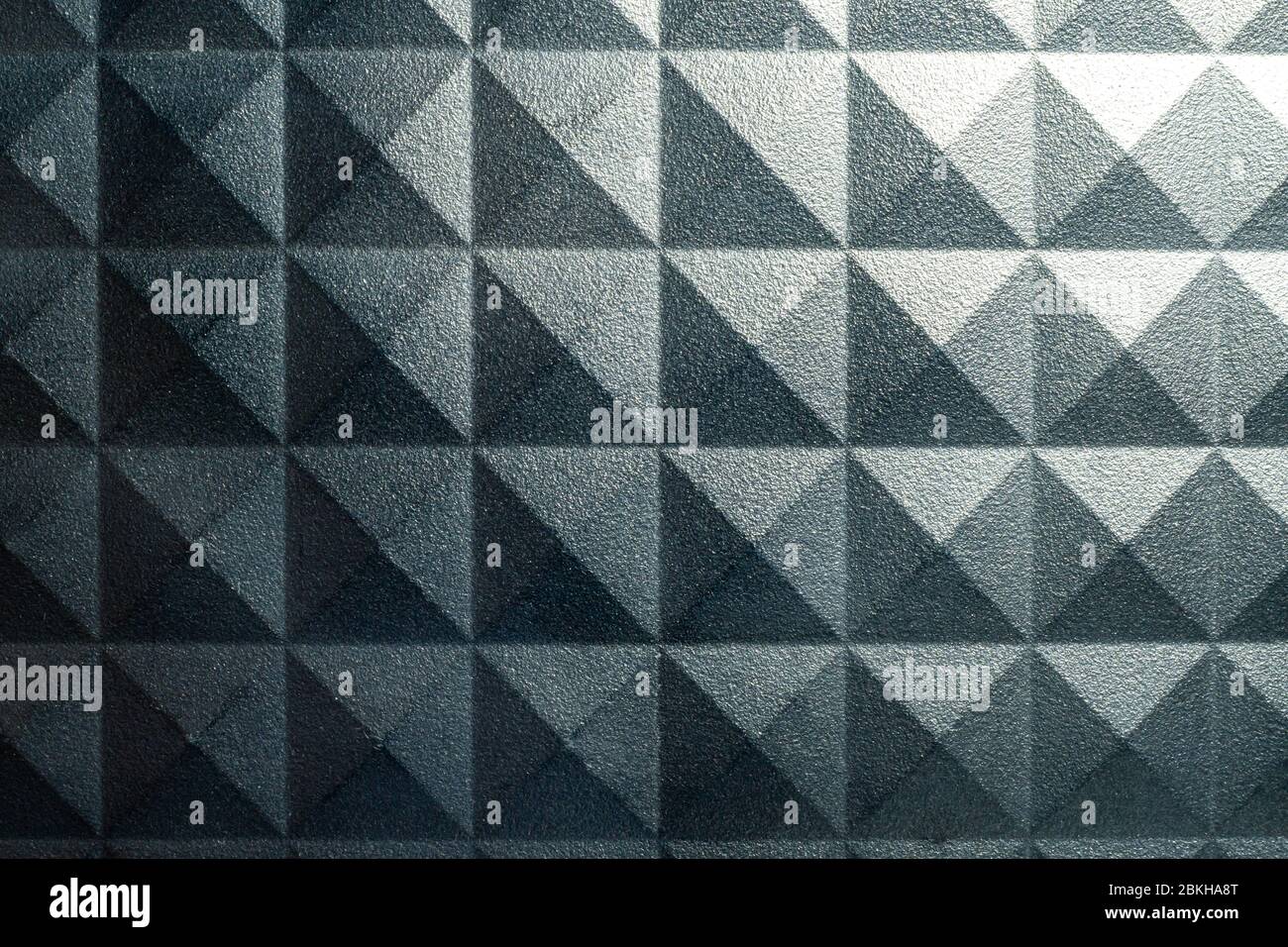 Pyramid pattern background with a rough surface and contrasting light ...