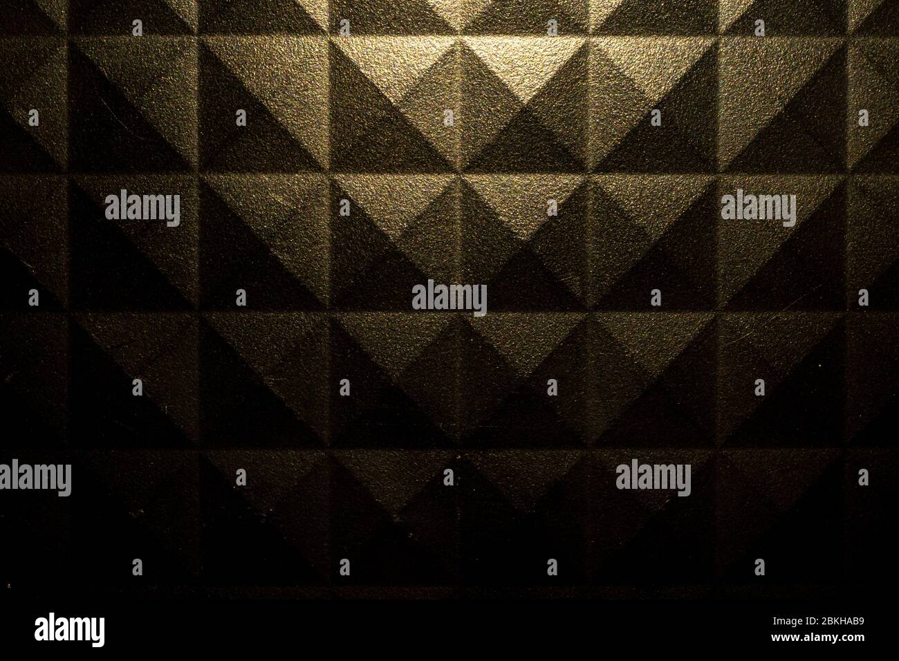 Pyramid pattern background with a rough surface and contrasting light ...