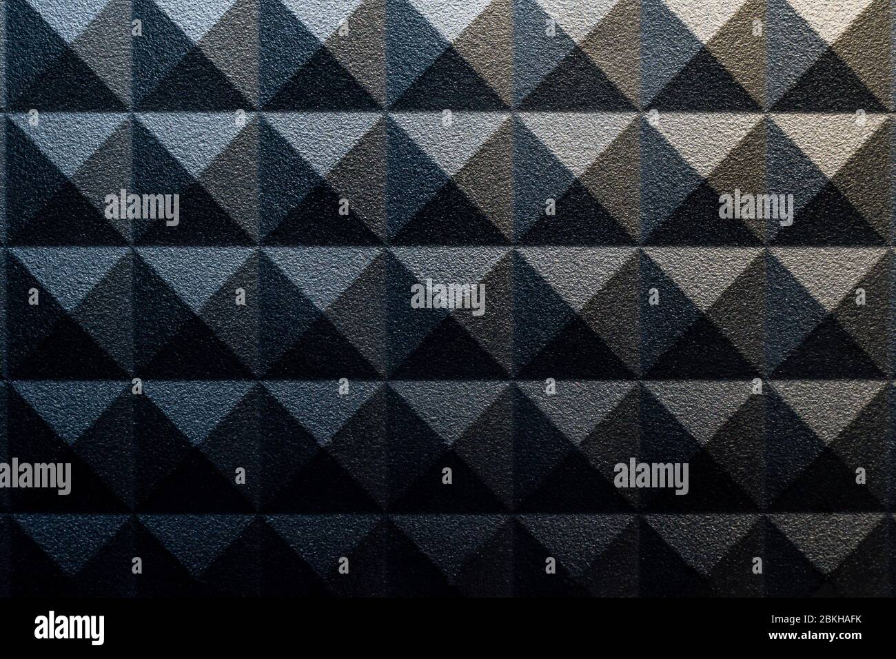 Pyramid pattern background with a rough surface and contrasting light ...