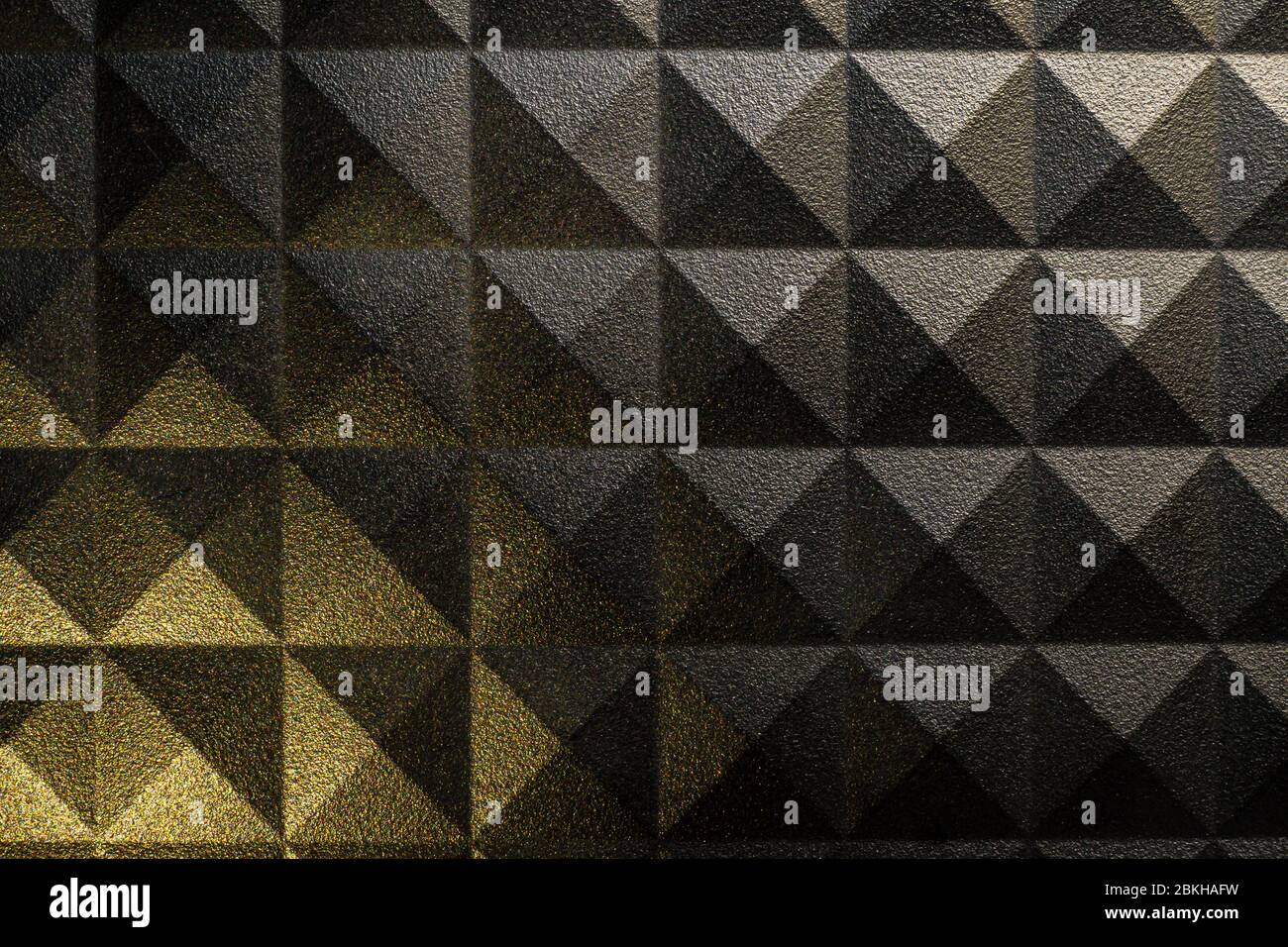 Pyramid pattern background with a rough surface and contrasting light ...
