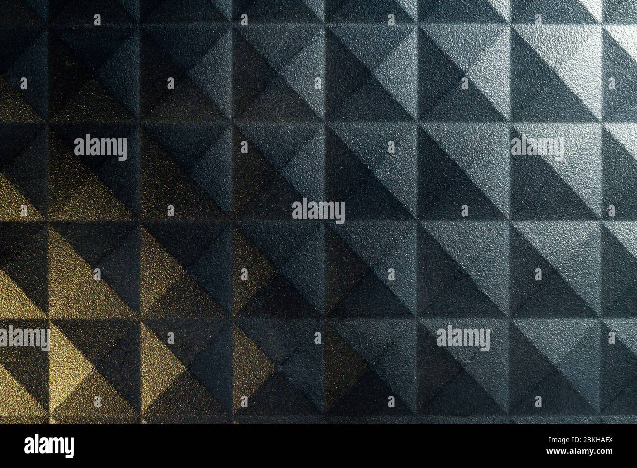 Pyramid pattern background with a rough surface and contrasting light ...
