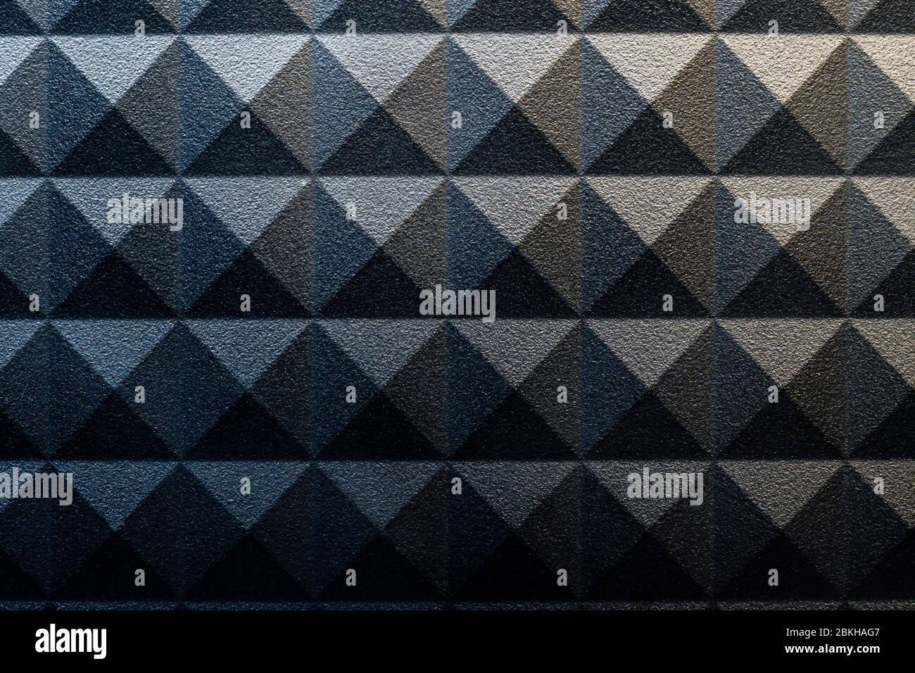 Pyramid pattern background with a rough surface and contrasting light ...