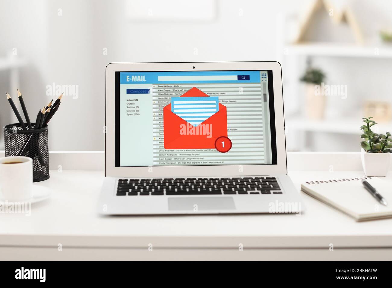 Laptop with open e-mail box on screen at workplace Stock Photo - Alamy