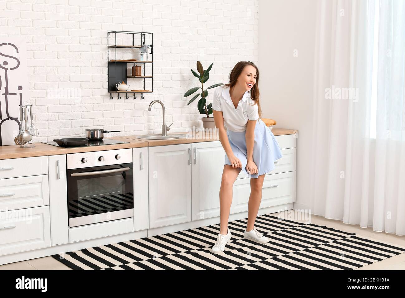 Beautiful young woman dancing at home Stock Photo - Alamy