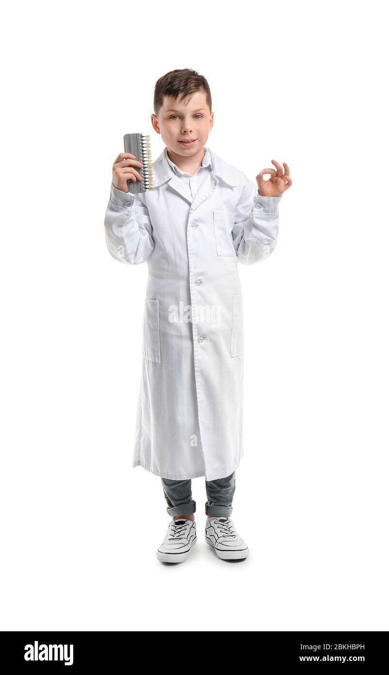 Little dentist with teeth color samples showing OK gesture on white ...