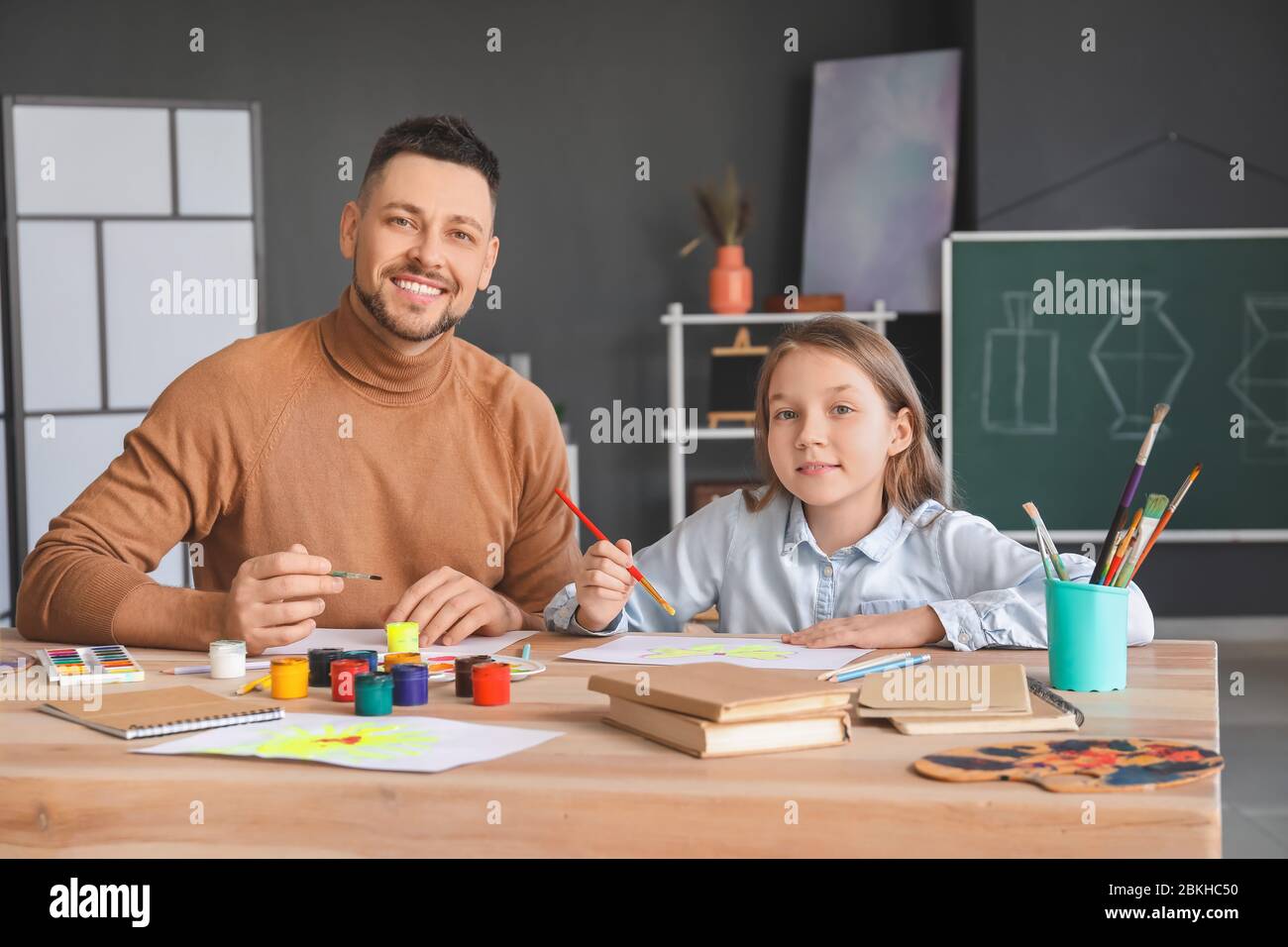 Drawing teacher giving optional classes at school Stock Photo - Alamy