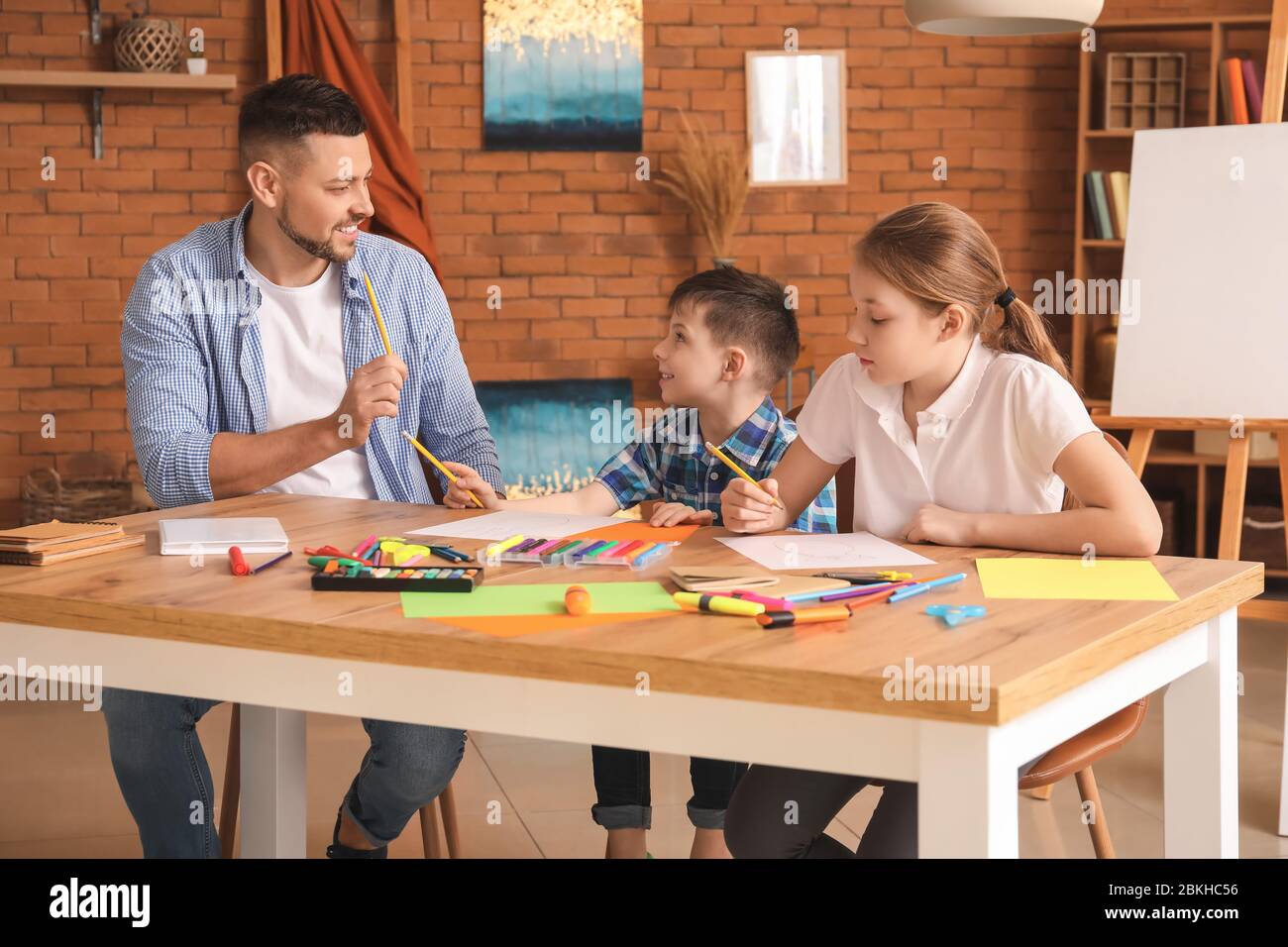 Drawing teacher giving optional classes at school Stock Photo - Alamy