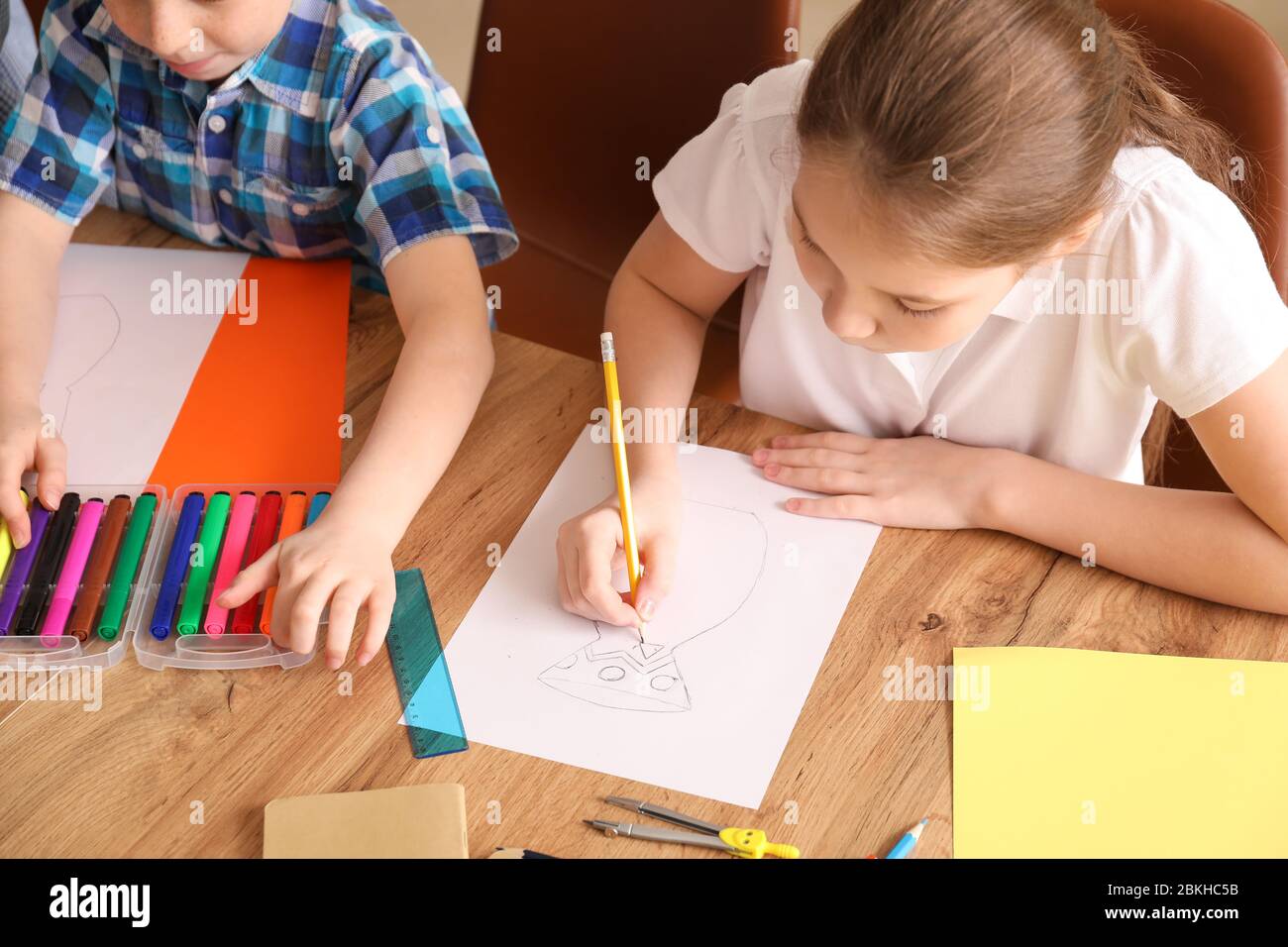 Cute children drawing at school Stock Photo - Alamy