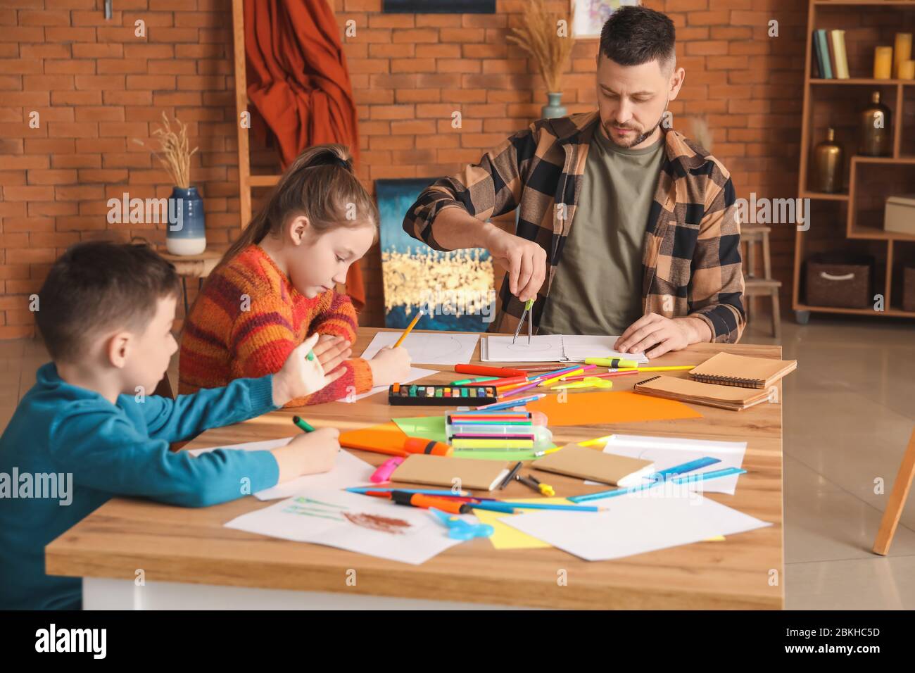 Drawing teacher giving optional classes at school Stock Photo - Alamy