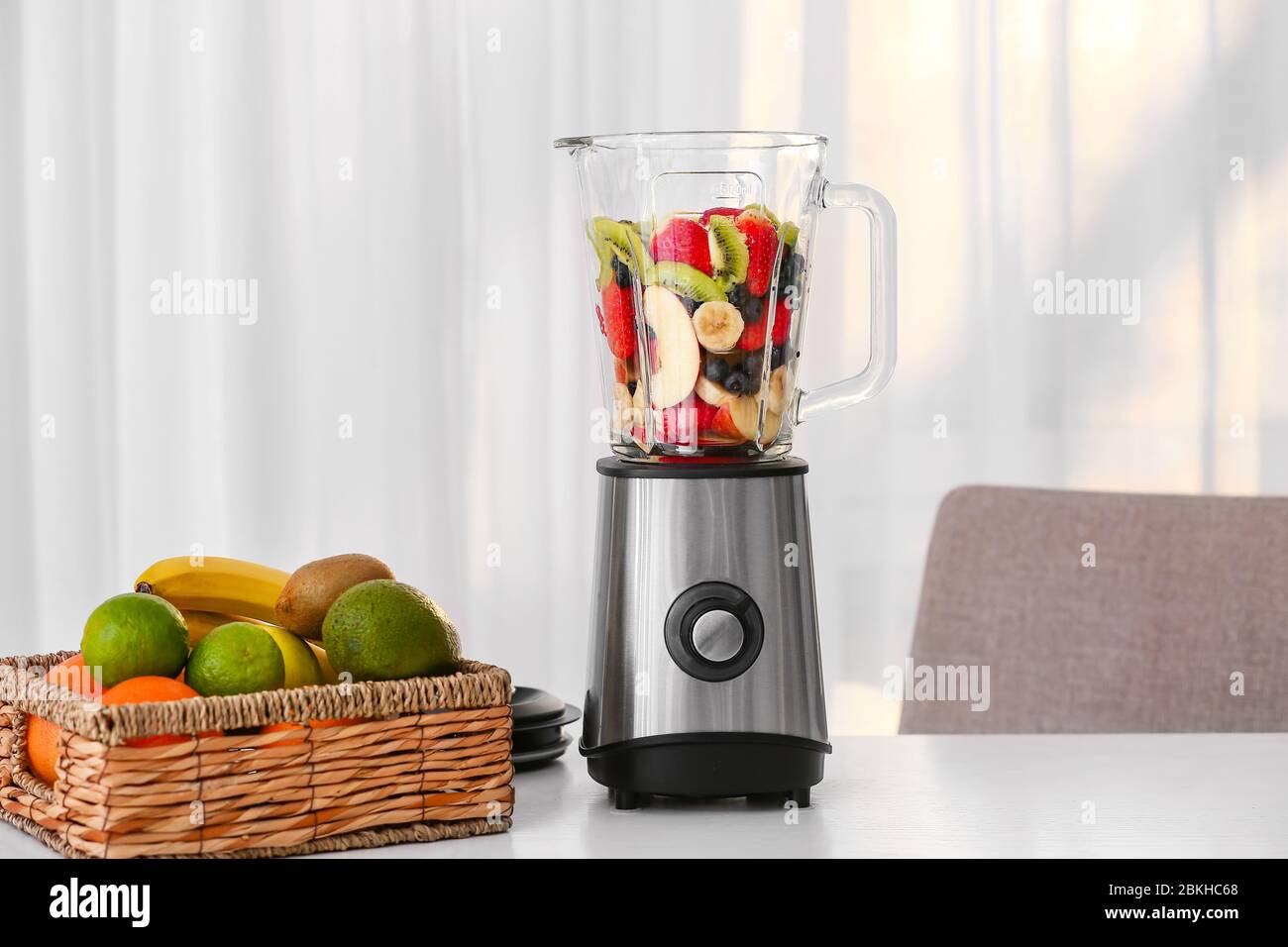 Modern blender and ingredients for healthy smoothie on kitchen table ...