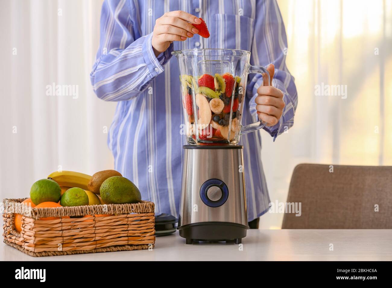 Woman making healthy smoothie at home, closeup Stock Photo - Alamy