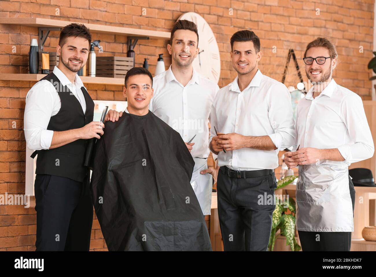 Professional hairdresser teaching young men in salon Stock Photo - Alamy
